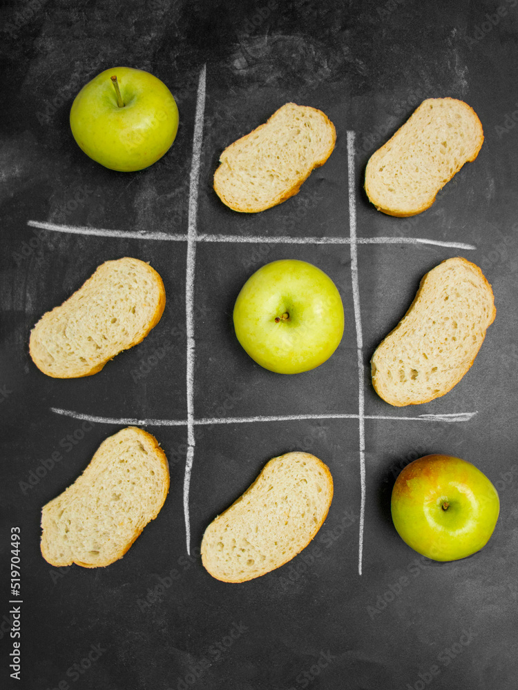 Tic-tac-toe game between harmful calories and healthy food, apples and ...