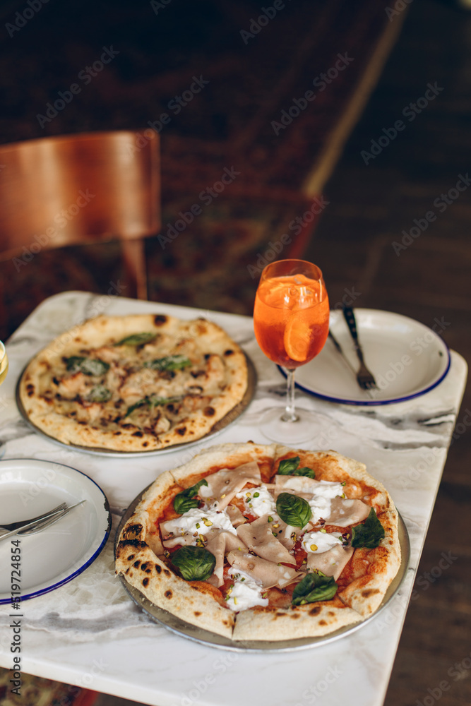 Foto de table setting in a pizzeria. two Italian pizzas with burnt ...