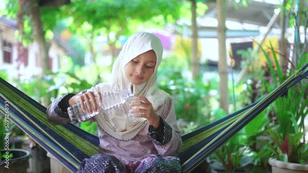 Islamic girl pouring water into a glass Stock ビデオ | Adobe Stock