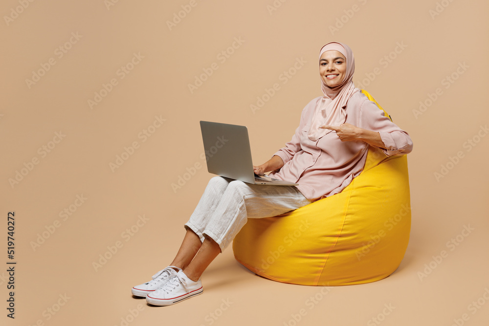 Full body young arabian asian muslim woman she wear abaya hijab sit in ...