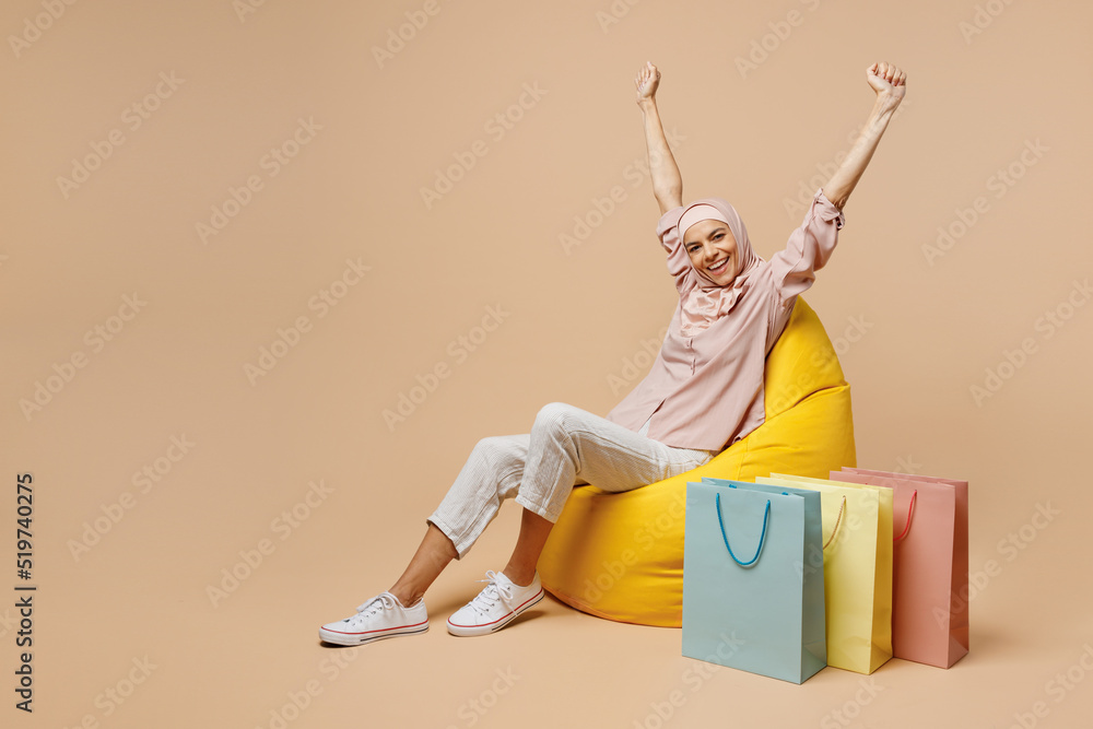 Full size fun young arabian asian muslim woman she wear abaya hijab sit ...