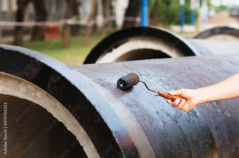 Construction roller in the man's hand. The process of painting ...