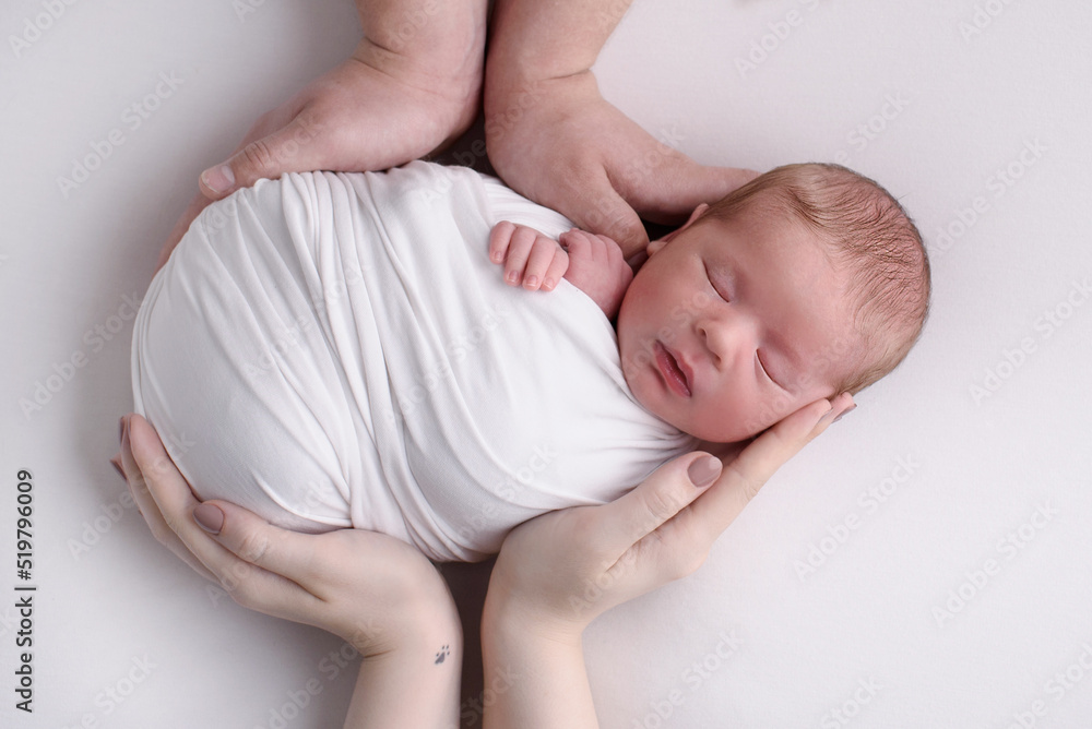 Newborn baby lying on hands of parents. Imitation of baby in womb ...