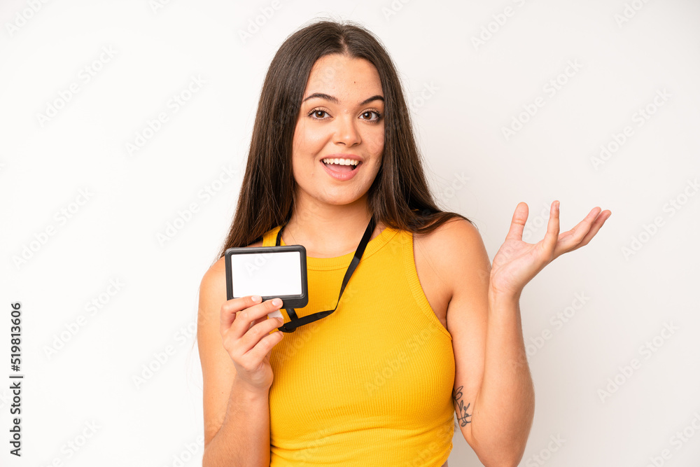 hispanic pretty woma looking happy, astonished and surprised. vip pass ...