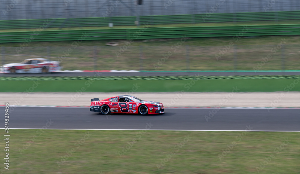 Red Nascar car racing action on track blurred motion background. Stock ...