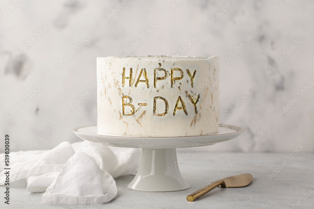 White birthday cake on a cake stand on white background. Simple ...