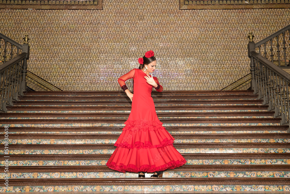 Young teenage woman in red dance suit with ruffles and red carnations ...