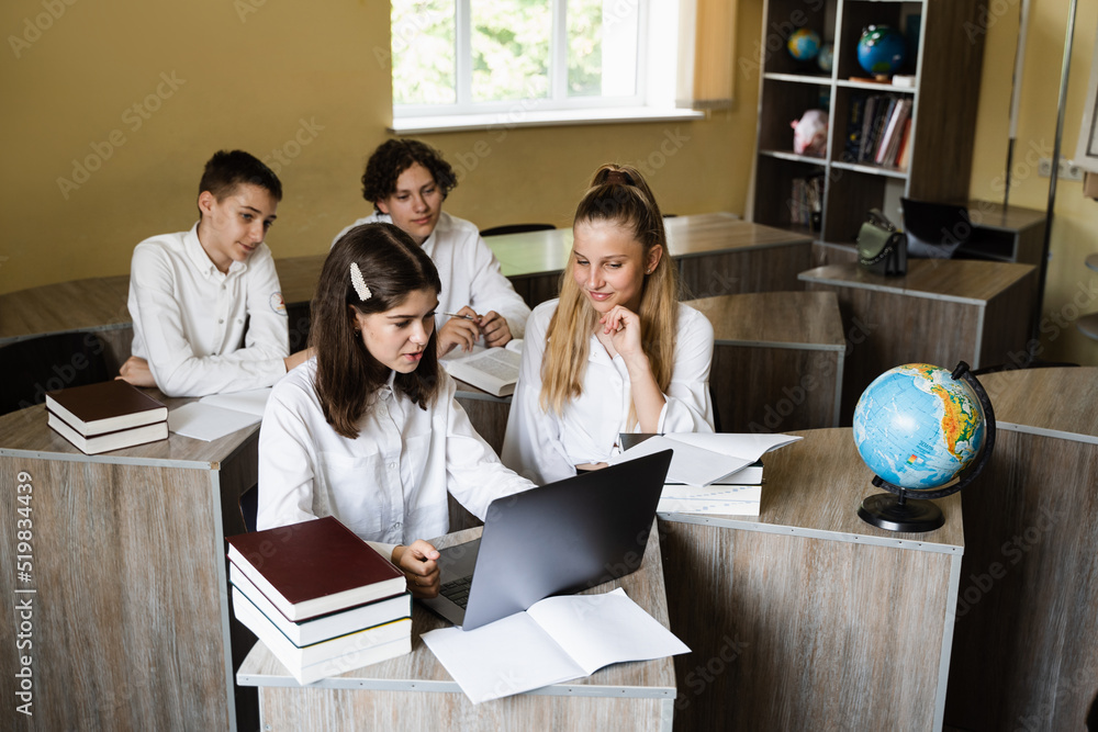 Children in school at geography lesson with globe study online on ...