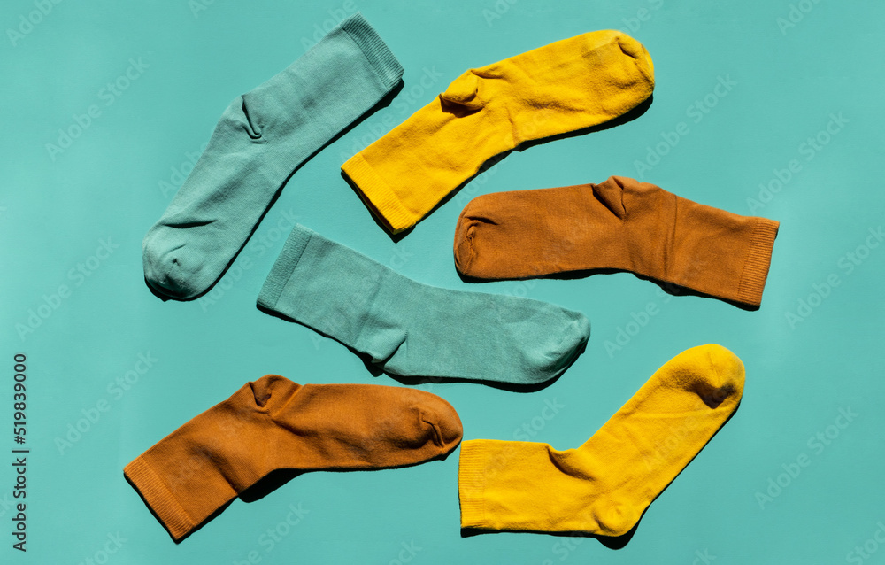 Some socks on turquoise background. Layout colourful socks. Stock Photo ...