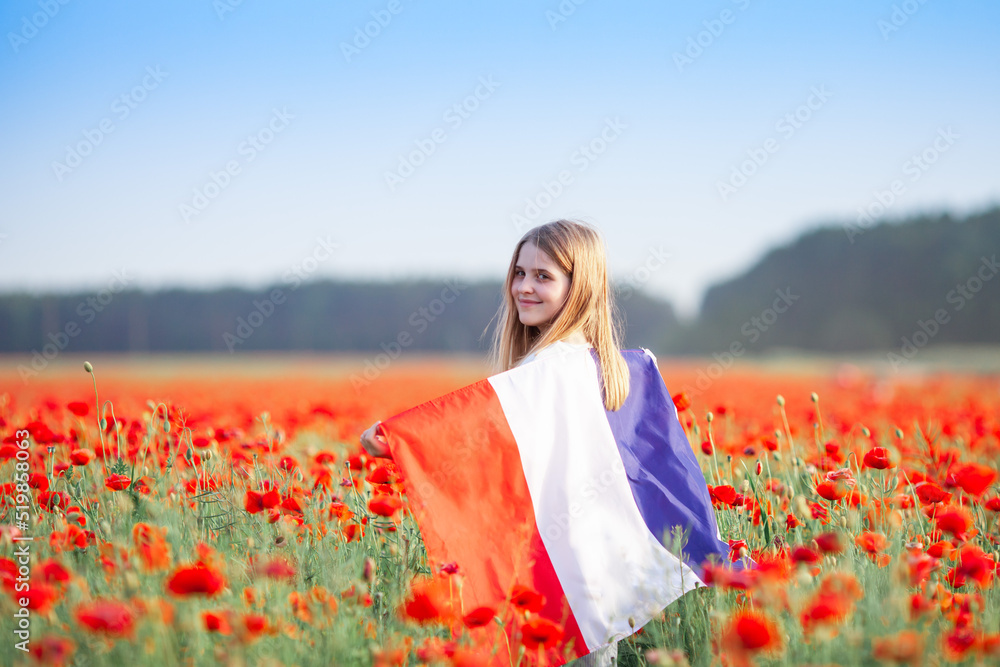 Happy girl holding flag of France in the poppy field. National holidays ...