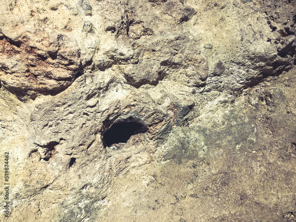 texture. cave made of stone with a hole. wall with scuffs and damage ...