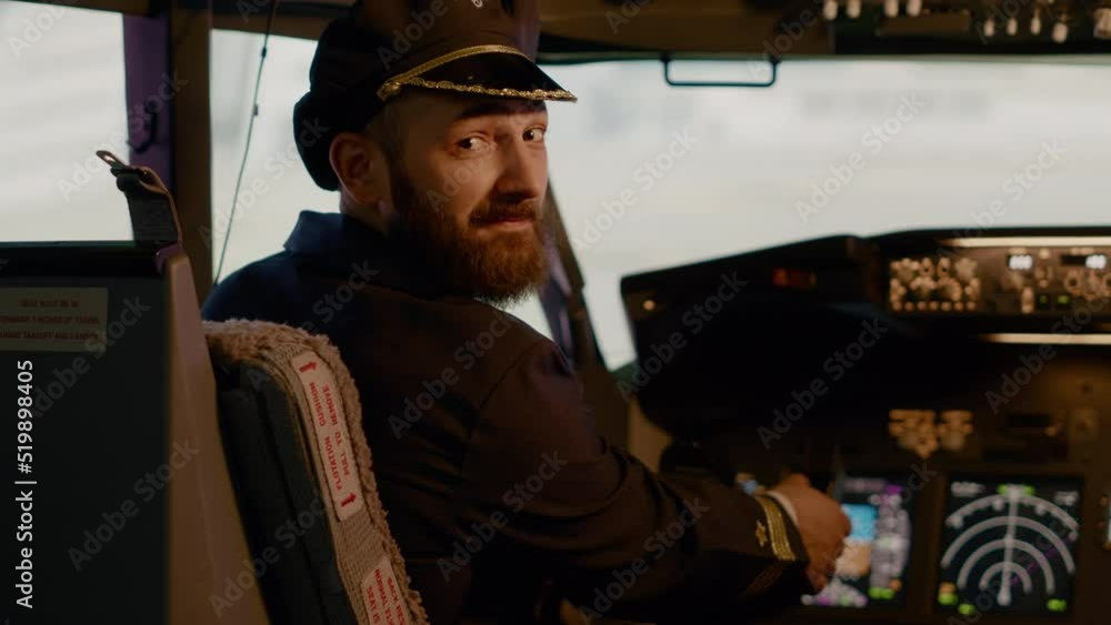 Portrait of airline captain sitting in pilot seat to fly airplane using ...