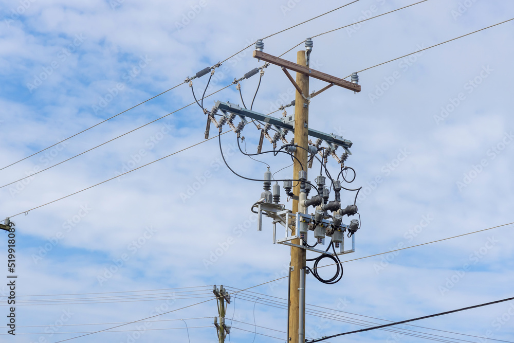 A wooden electric pole pillar is on instaled with electrical wires ...