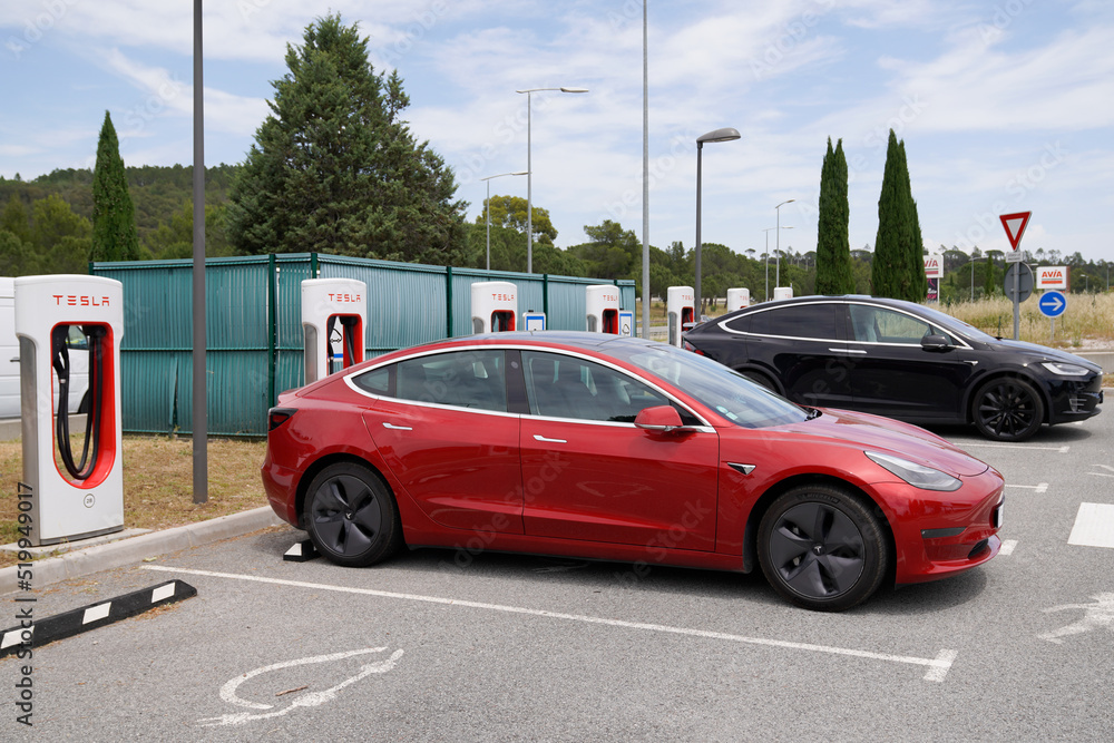 tesla model 3 red in charging station supercharger power supply for ...