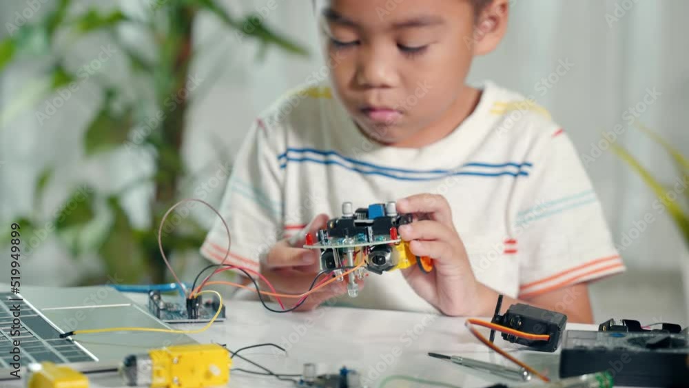 Wideo Stock: Asian kid boy assembling wheel into Arduino robot car ...