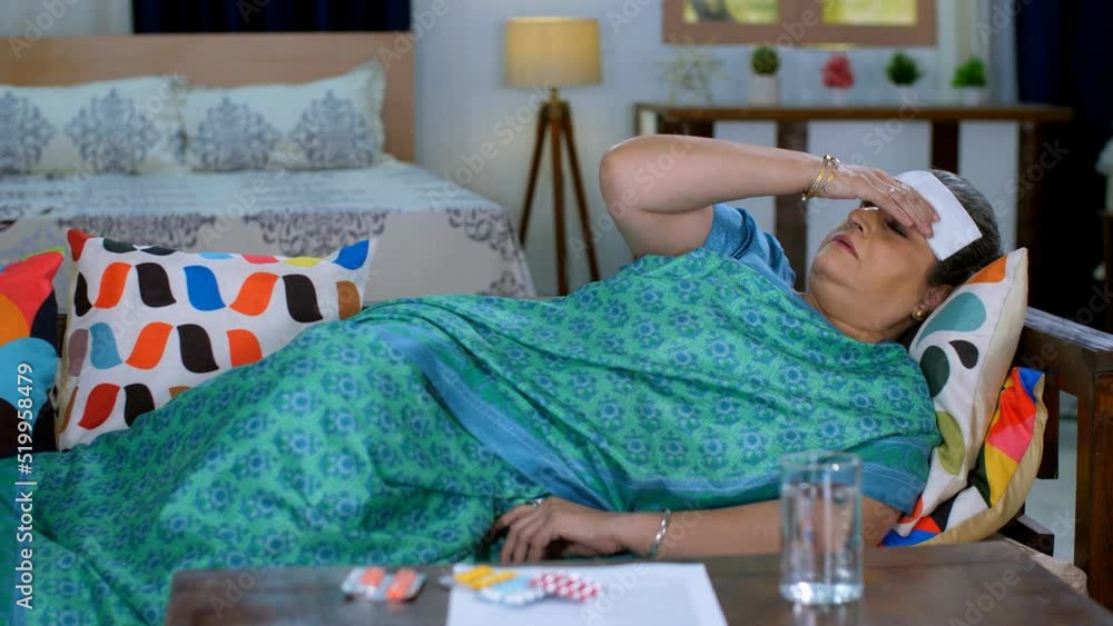 A senior Indian woman suffering from flu resting at home - a viral ...