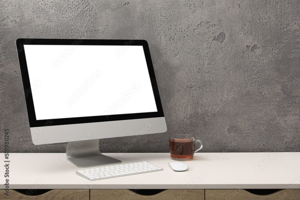 Workplace with modern computer monitor, keyboard and mouse on table ...