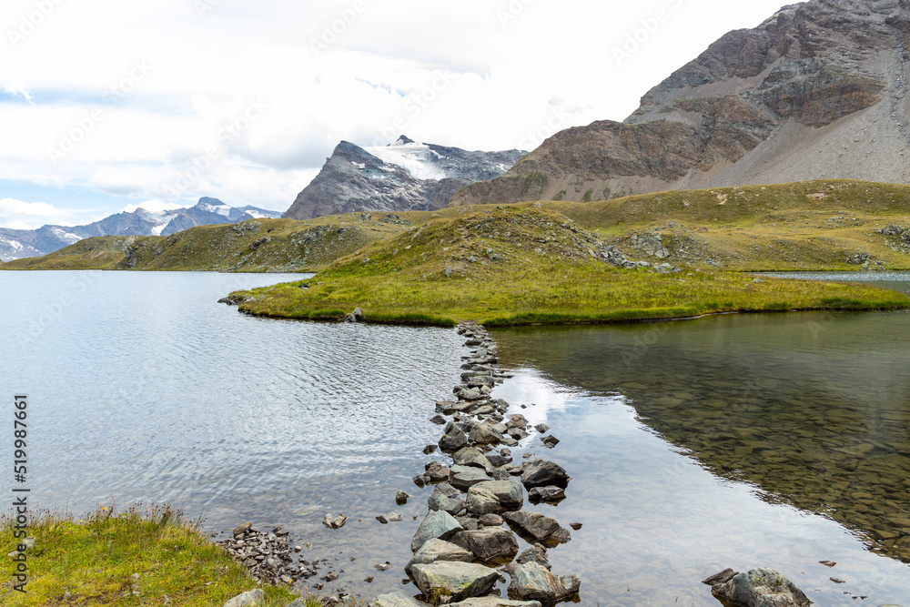 Excursion to the Gran Paradiso in the Alps. Stone walkway built into ...