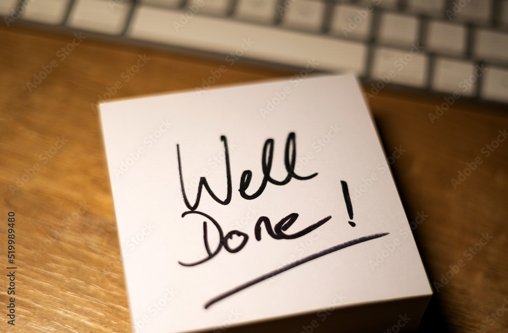 Well Done, text note. Office desk with notepad and keyboard in the ...