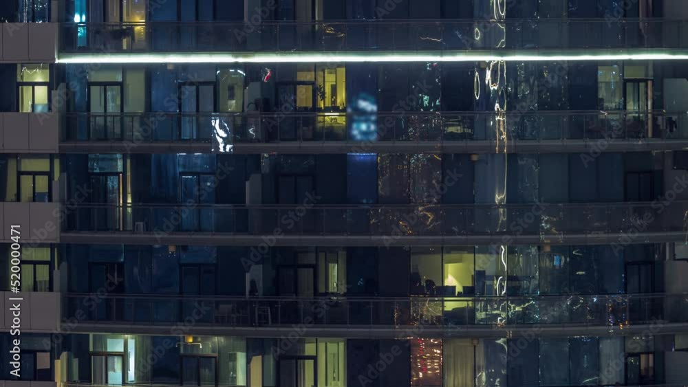 Big glowing windows in modern office and residential buildings ...