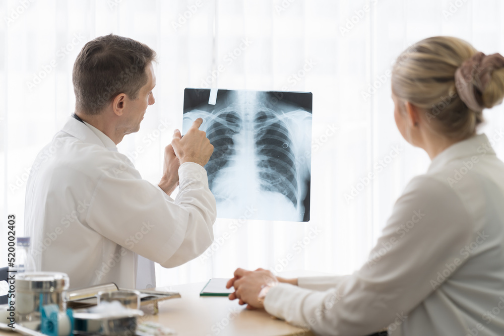 Doctor, patient and x-ray. Male doctor and woman patient doing analysis ...