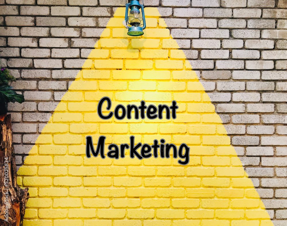content marketing - text on yellow brick wall with sign Stock Photo ...
