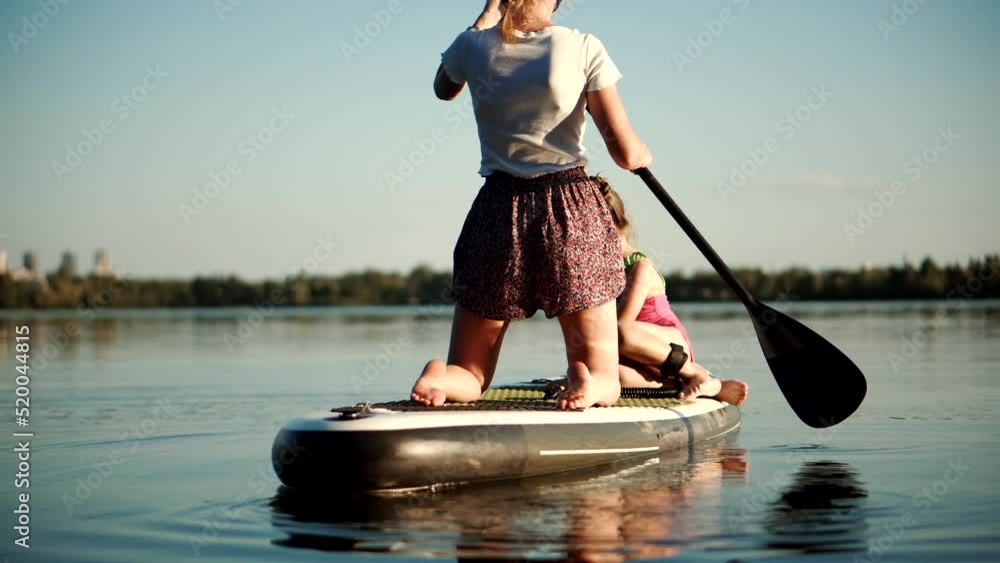 Mother With Daughter Floating On Sup Board. Family Relationship ...