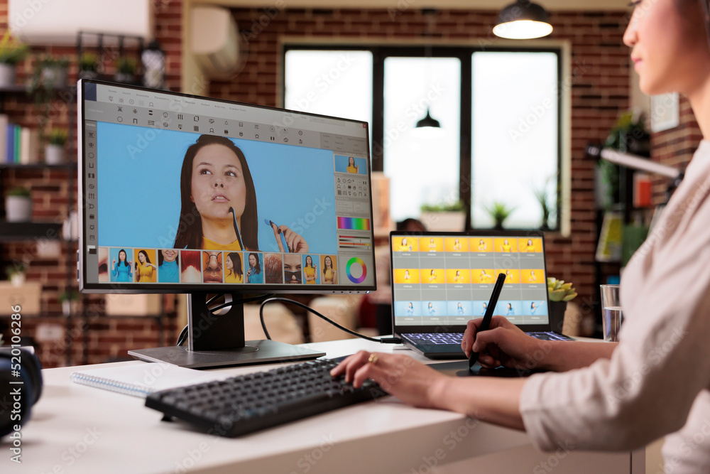 Asian photographer editing picture with retouching software on computer ...