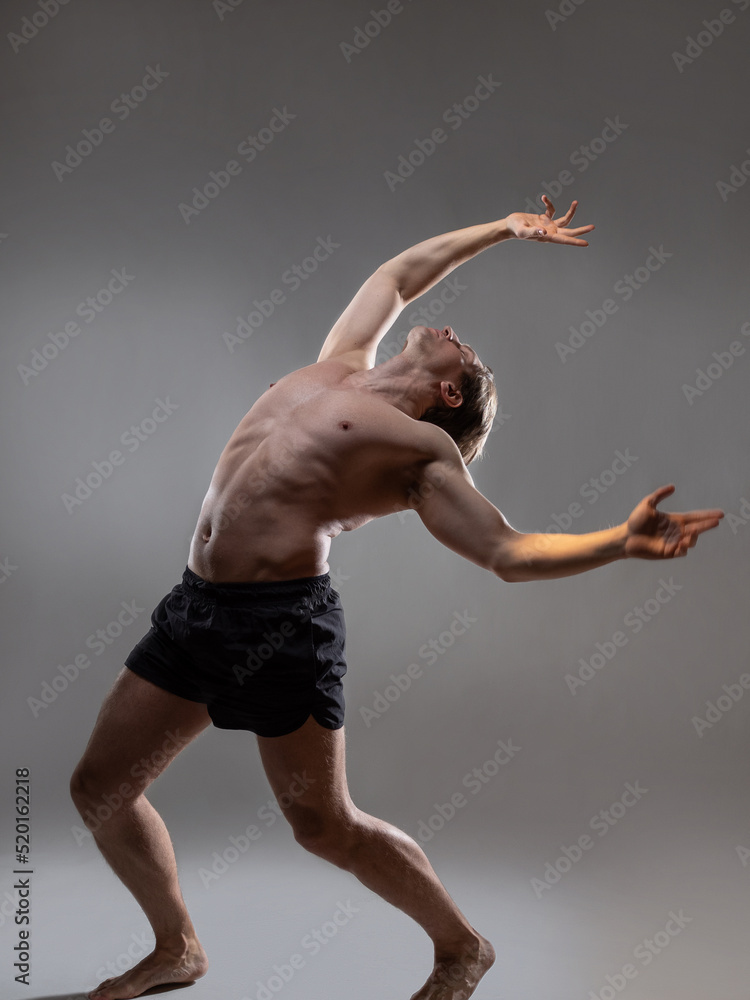 young muscular man in an expressive pose, artistic pose of the hero ...