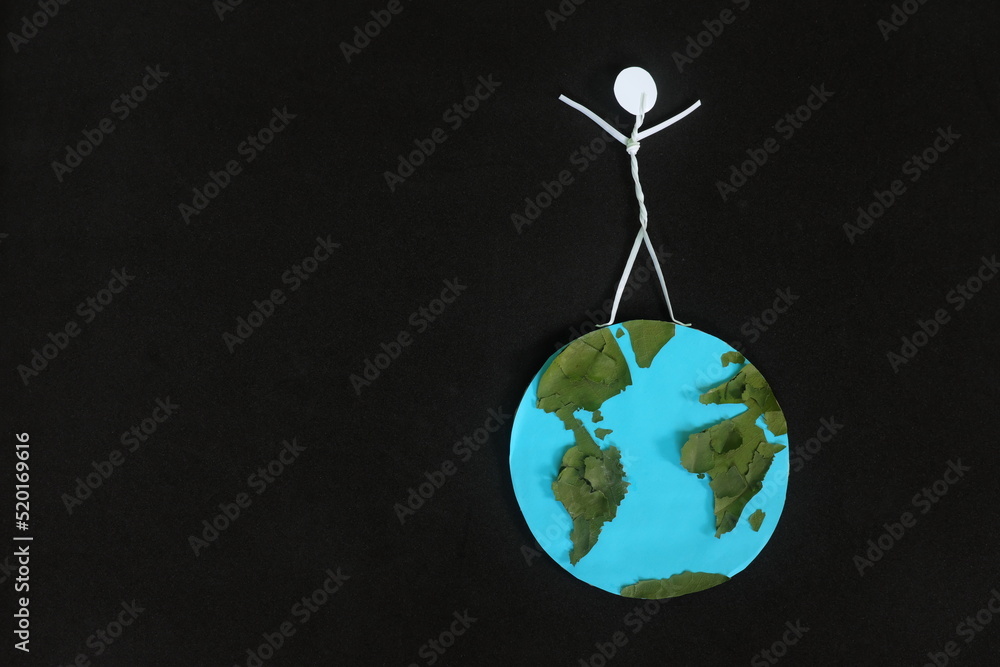 Human stick figure standing on top of planet earth in dark black ...