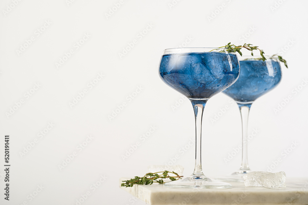 Dark blue drink in a vintage glass for sparkling wine - pea flower tea ...