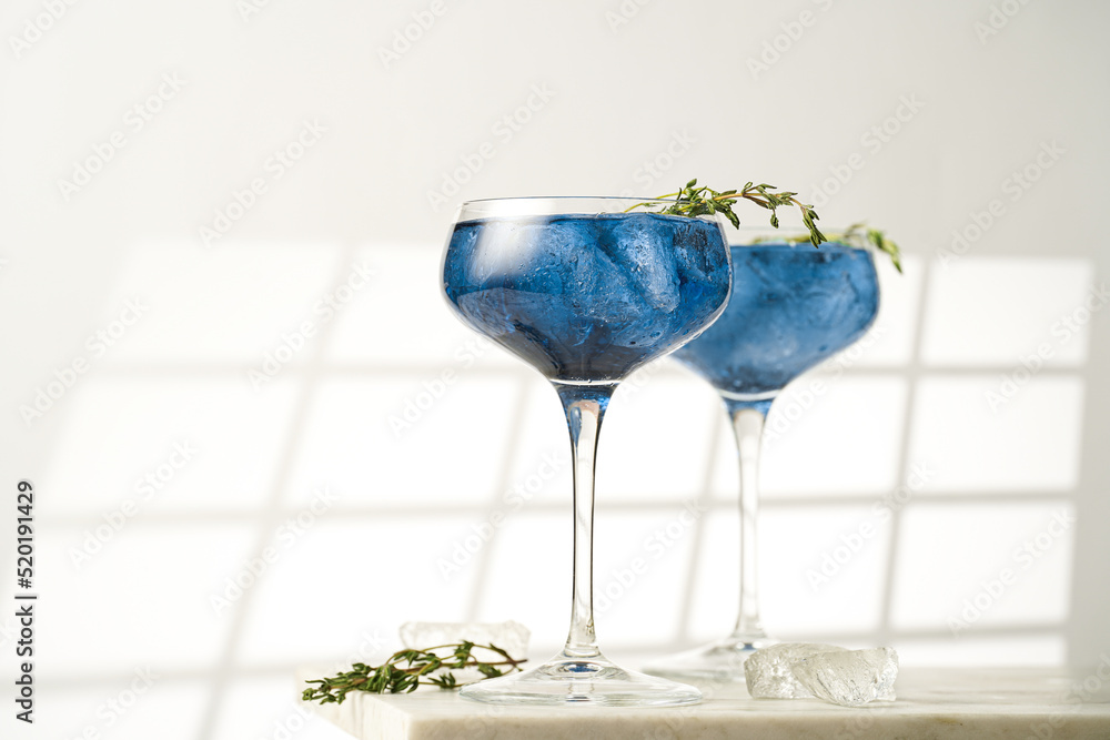 Dark blue drink in a vintage glass for sparkling wine - pea flower tea ...