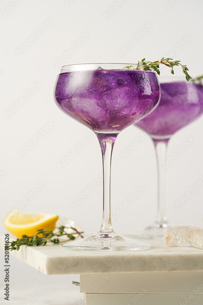 a purple drink in a vintage glass for sparkling wine - pea flower tea ...