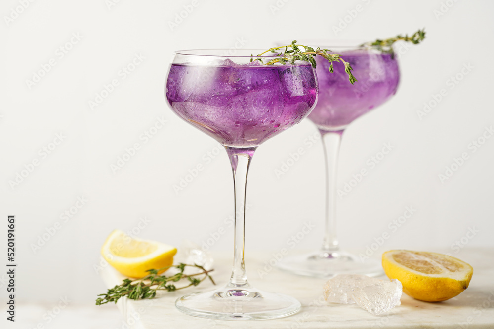 a purple drink in a vintage glass for sparkling wine - pea flower tea ...