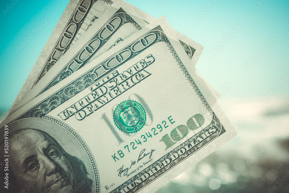 Girl holding money bill of 300 dollars on background of sea ocean waves ...