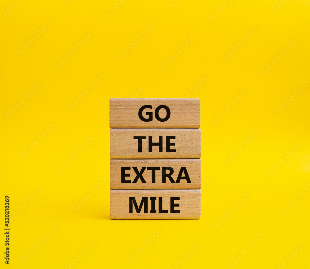 Go the extra mile symbol. Wooden blocks with words Go the extra mile ...