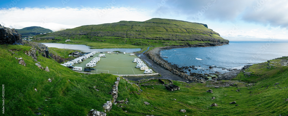 Fotka „View of an old soccer field with a picturesque cliff on the ...
