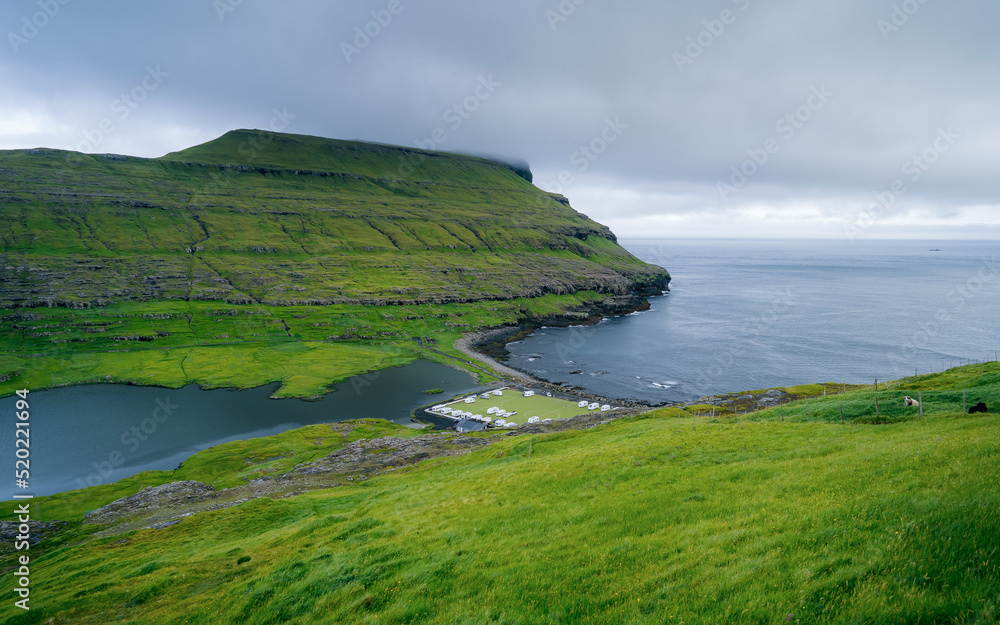 View of an old soccer field with a picturesque cliff on the coast near ...