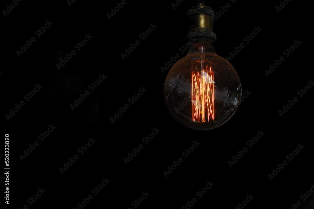 Electrical filament of a vintage Edison bulbs lamp on a black ...