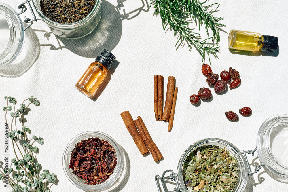 Variety of herbs and herbal mixtures on linen surface top view ...