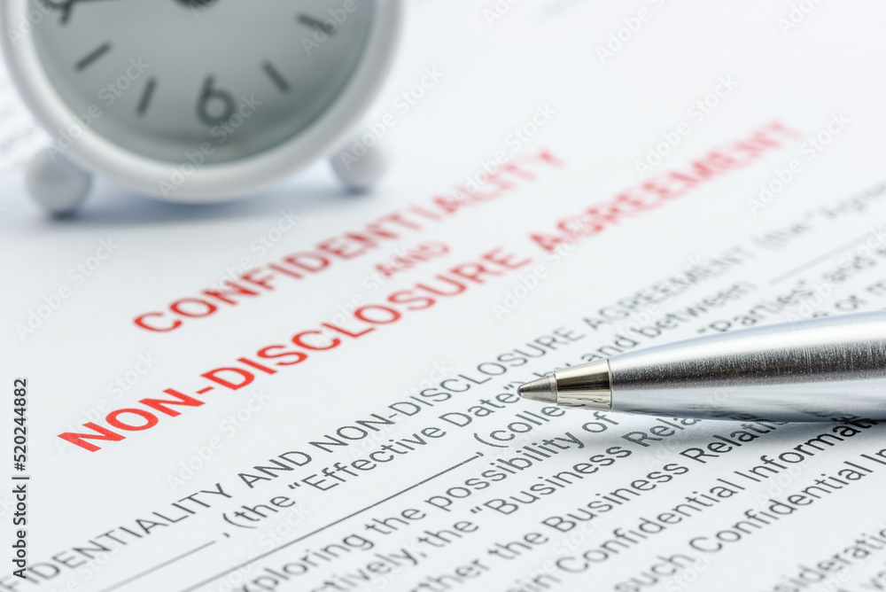Confidentiality and non-disclosure agreement form and a pen, business ...