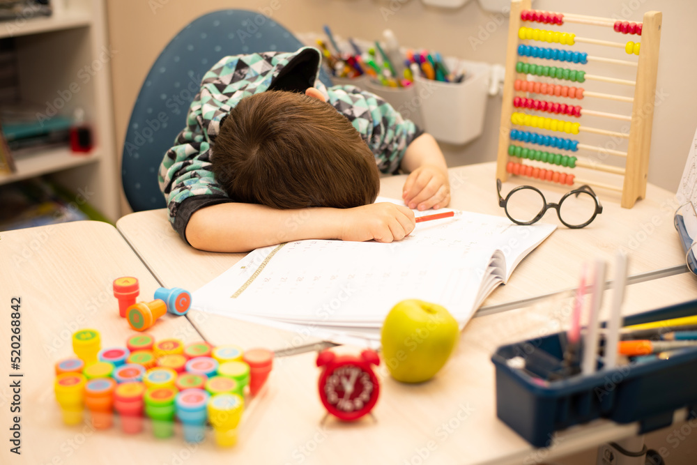 Sleeping tired child boy at the desk Stock Photo | Adobe Stock