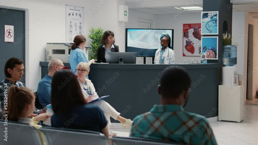 Busy hospital reception with diverse group of patients in waiting room ...