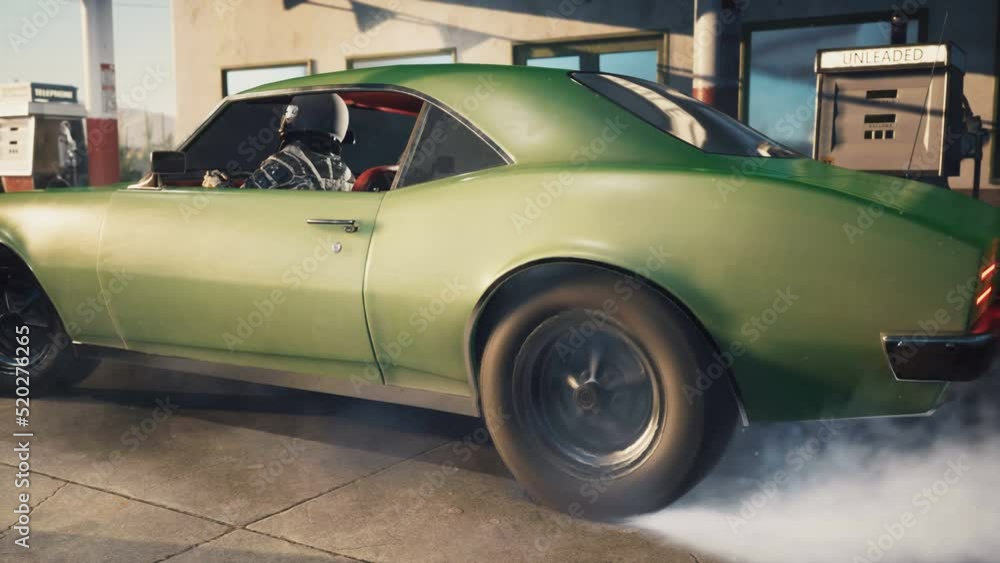 An astronaut prepares to start racing in his fast vintage car. Smoke ...