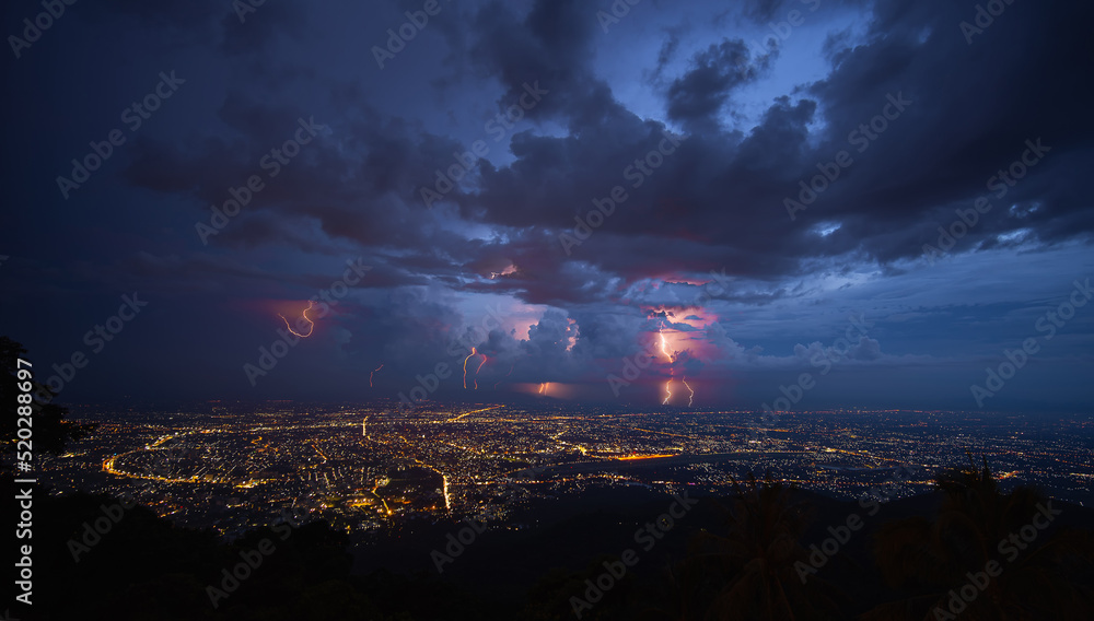 Lightning storm over city. Dangerous storm with a strong wind swirls ...