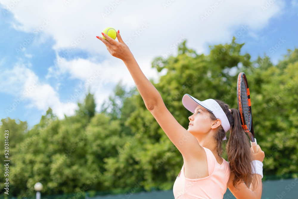 Professional equipped female tennis player beating hard the tennis ball ...