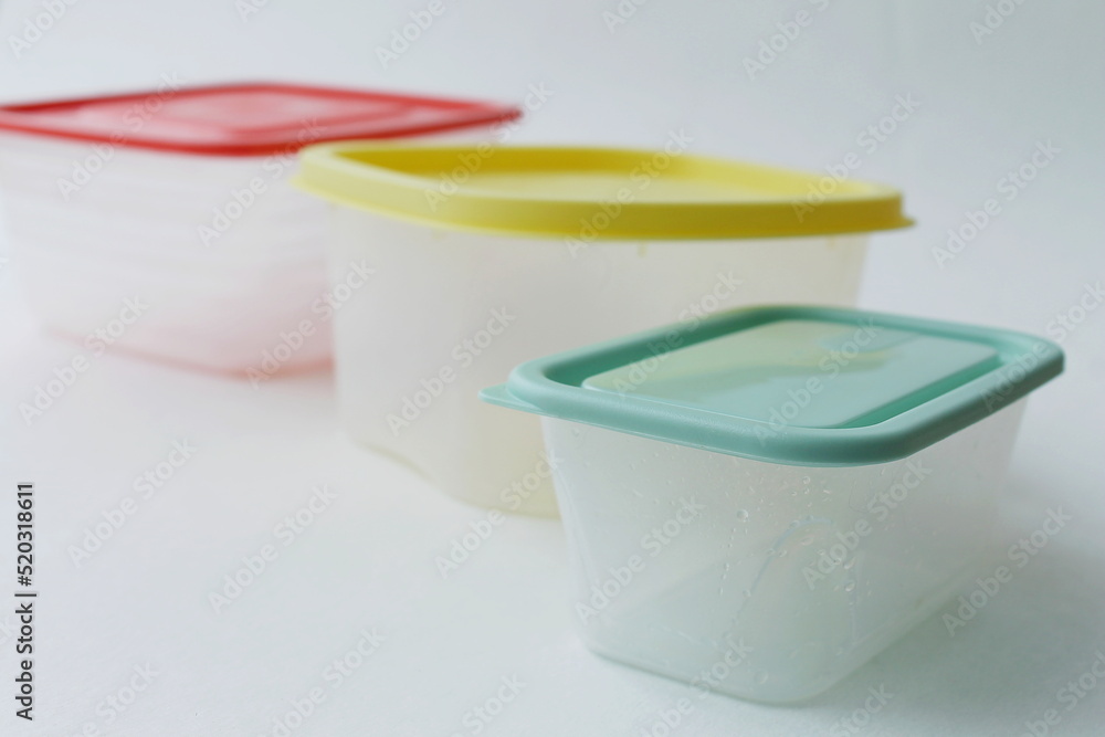 container with red lid, container with yellow lid, container with green ...