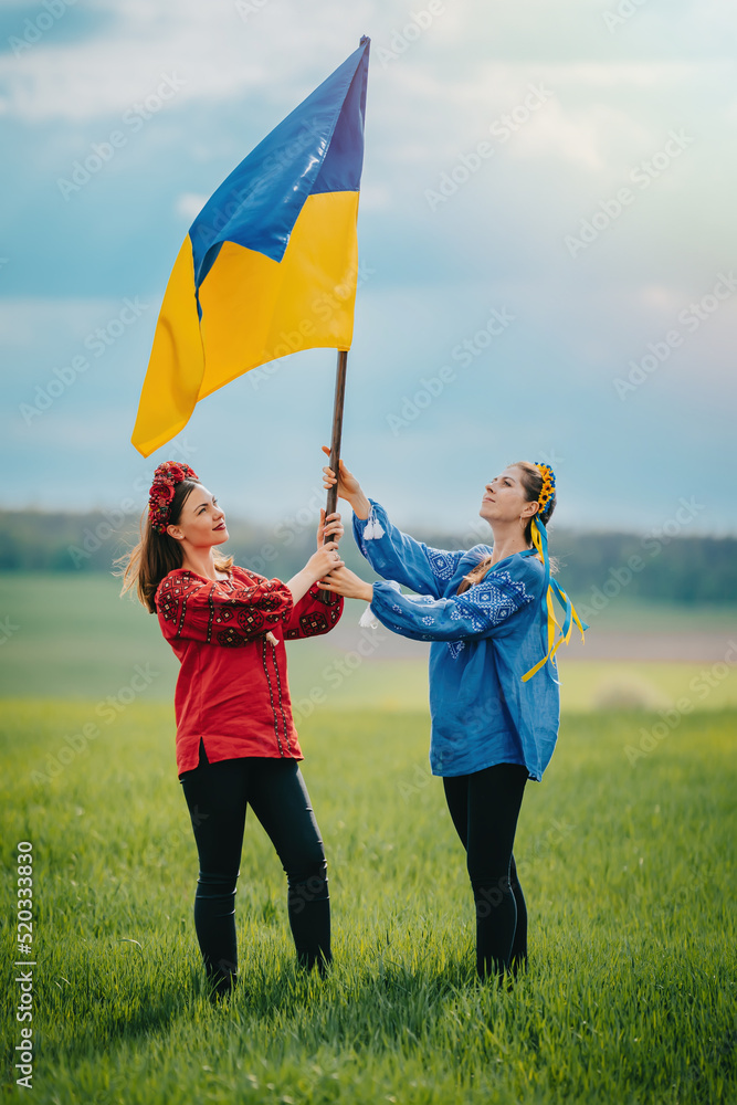 Happy ukrainian women raised national flag, it flies as symbol of love ...