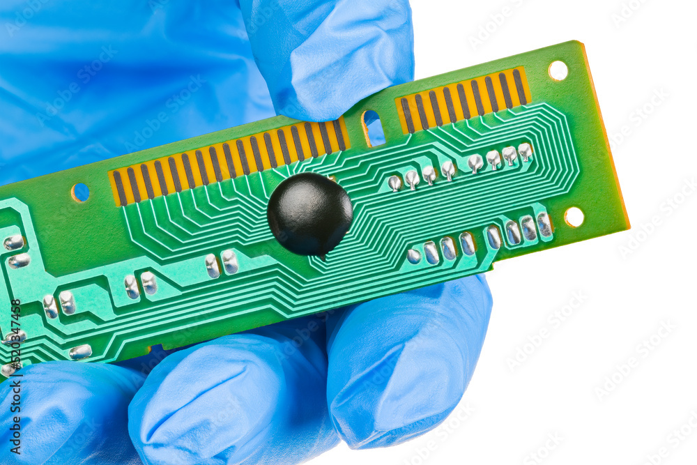 Closeup of electronic chip on board in engineer gloved hand isolated on ...