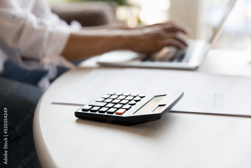 Calculator and paper documents on table of homeowner, freelancer ...